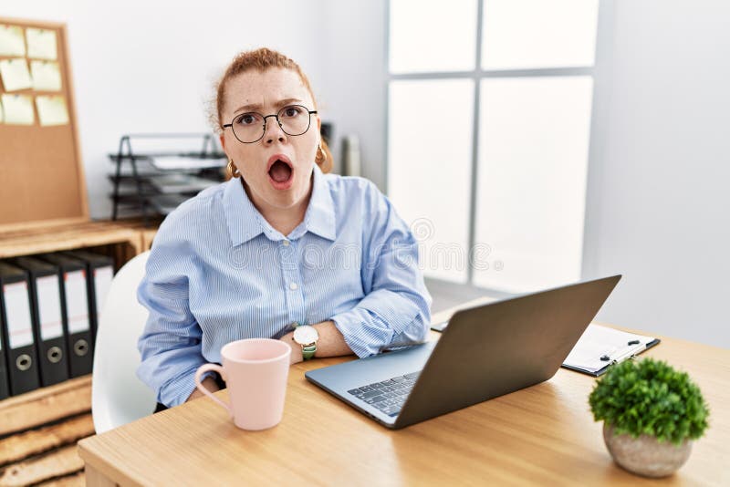 Young Redhead Woman Working at the Office Using Computer Laptop in ...
