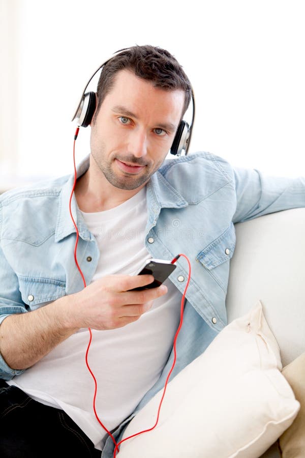 Young Relaxed Man Listening Music in a Sofa Stock Image - Image of ...