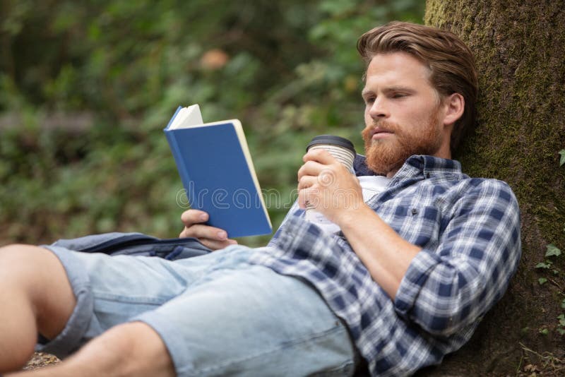 Young Relaxed Man Reading Book in Nature Stock Photo - Image of ...