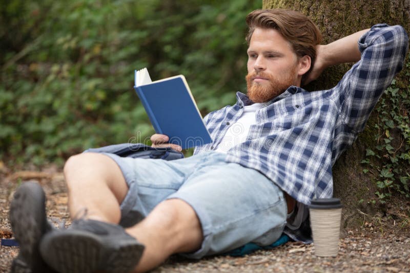 Young Relaxed Man Reading Book in Nature Back on Tree Stock Image ...
