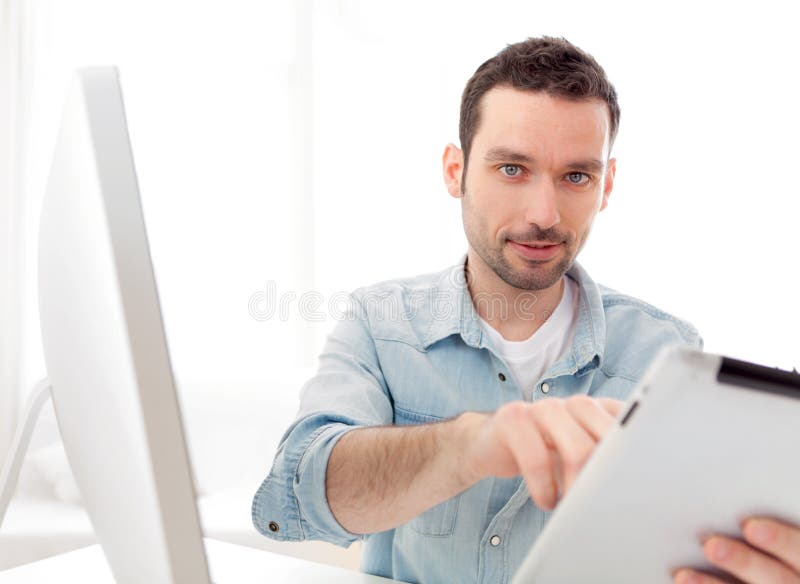 Young Relaxed Man Using Tablet at Home Stock Photo - Image of handsome ...