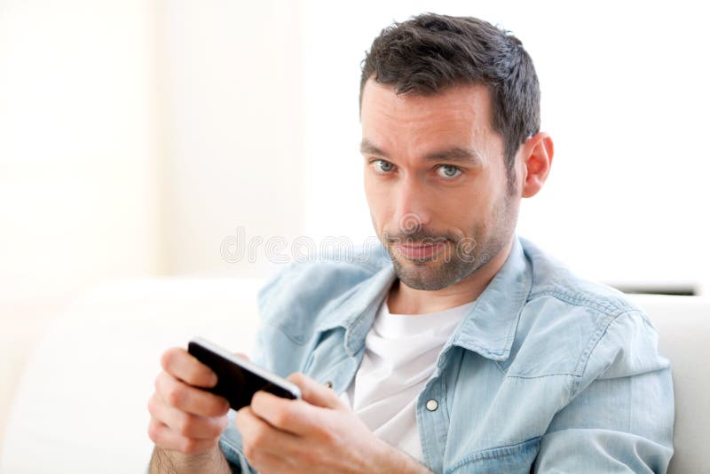Young Relaxed Man Writting Text in the Sofa Stock Photo - Image of ...