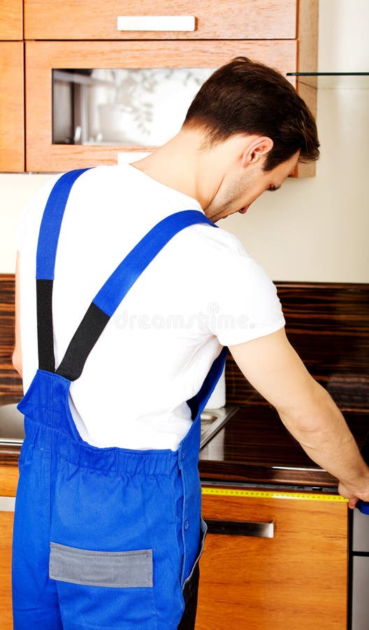 Young Repair Man Measuring Kitchen Cabinet Stock Photo - Image of ...