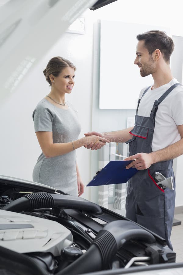 Car Mechanic Giving Client Keys To His Repaired Car in Auto Repair ...