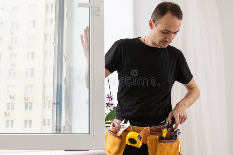 Young Repairman Fixing Window Frame in Room at Daytime Stock Photo ...