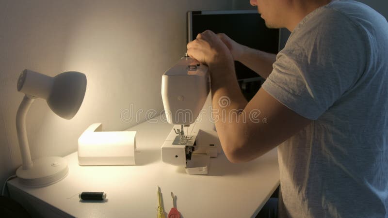 Young Repairman Master is Repairing Sewing Machine Sitting at Table ...