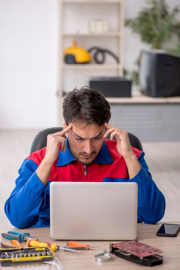 Young Male Repairman Repairing Computer Stock Photo - Image of ...