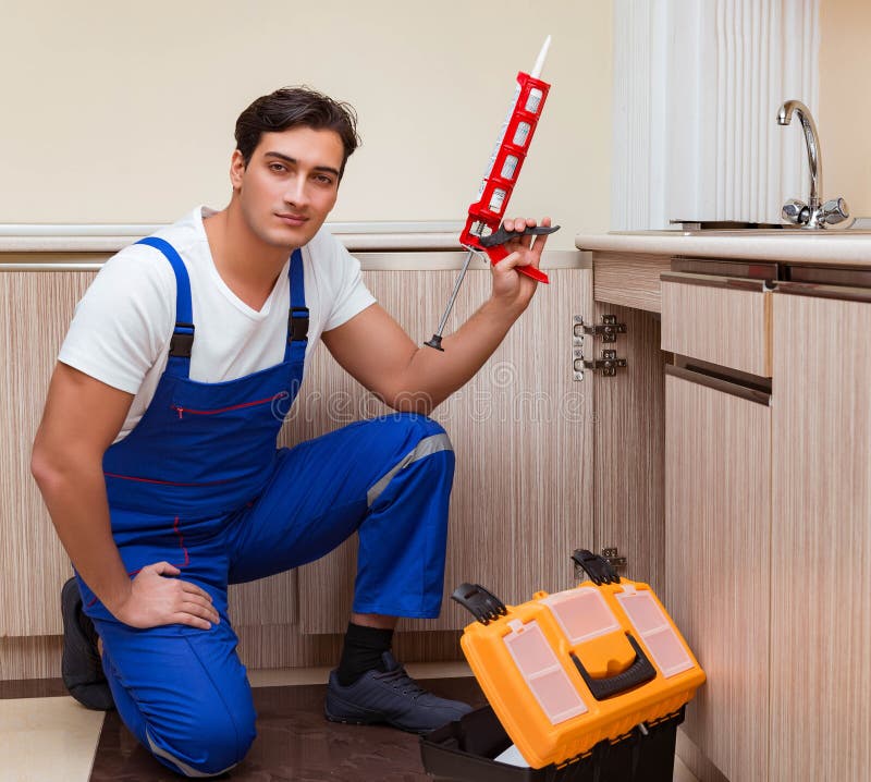 Young Repairman Working at the Kitchen Stock Image - Image of pipes ...