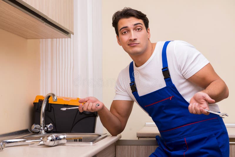 The Young Repairman Working at the Kitchen Stock Image - Image of ...