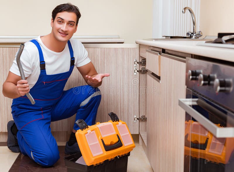 Young Repairman Working at the Kitchen Stock Photo - Image of ...