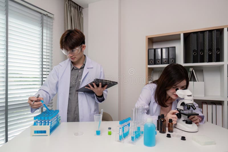 Researcher Performing Dual Experimentation: Microscope Analysis and ...