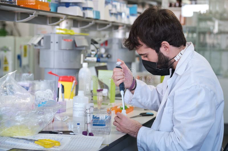Young Researcher Wearing Protective Face Mask Working in a Real ...