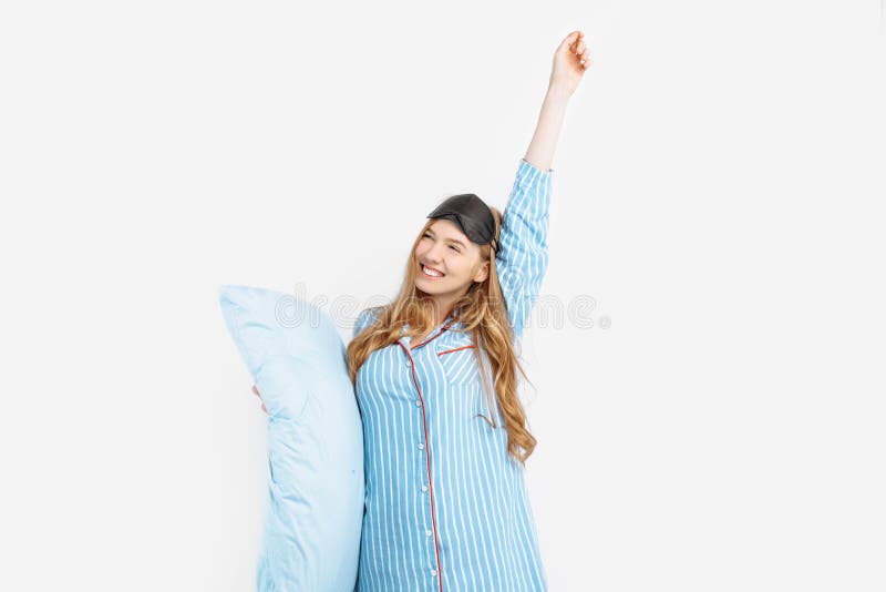 Young Rested Woman In Pajamas Stretching With Hands Raised Morning On