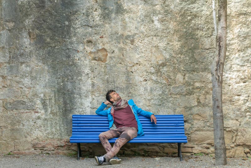 Young Romantic Man Sitting Alone on Bench in Front Stone Wall Stock ...