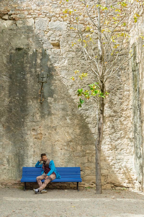 Young Romantic Man Sitting Alone on Bench in Front Stone Wall Stock ...