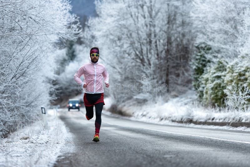 Young Runner on Ice Cold Roiad on the Alps Stock Image - Image of ...
