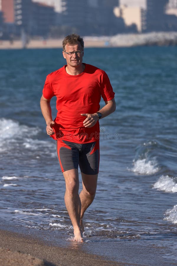 Young Runner Running in Red T-shirt at Springtime on the Spanish Beach ...