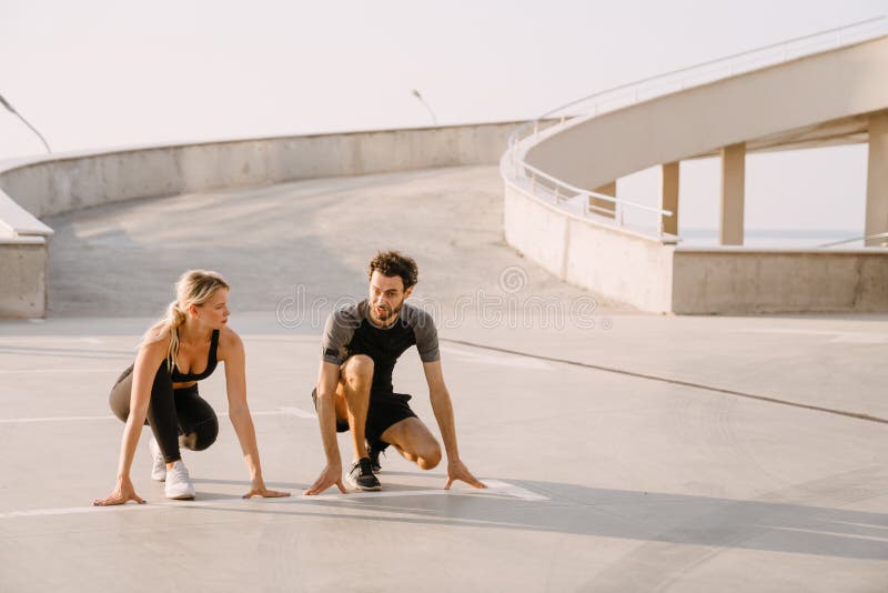 Young Runners Doing Exercise while Working Out Together on Parking ...