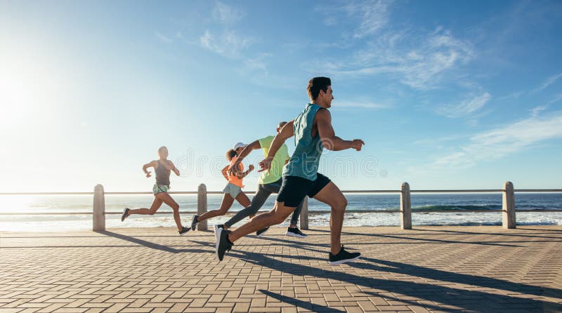 Young Runners Sprinting on the Ocean Front Path Stock Image - Image of ...