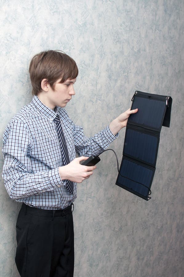 The Young Russian Guy Holds the Solar Panel in Hand Stock Photo - Image ...