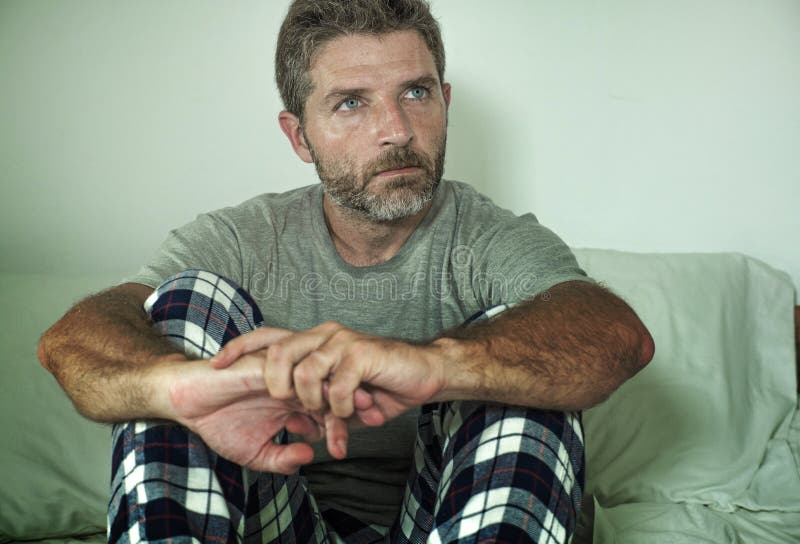 Young Sad and Depressed Man Lying Thoughtful and Pensive on Bed Looking ...