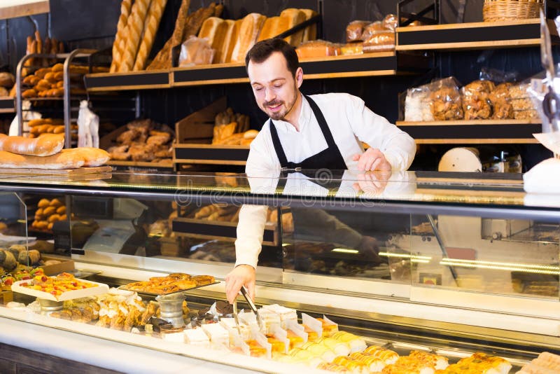 Salesman Shows the Types of Cakes Stock Photo - Image of helpful ...
