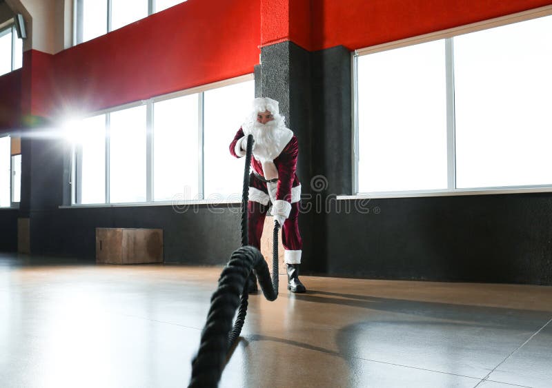 Young Santa Claus Training with Ropes in Gym Stock Image - Image of ...
