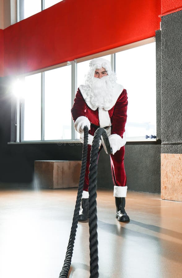 Young Santa Claus Training with Ropes in Gym Stock Image - Image of ...