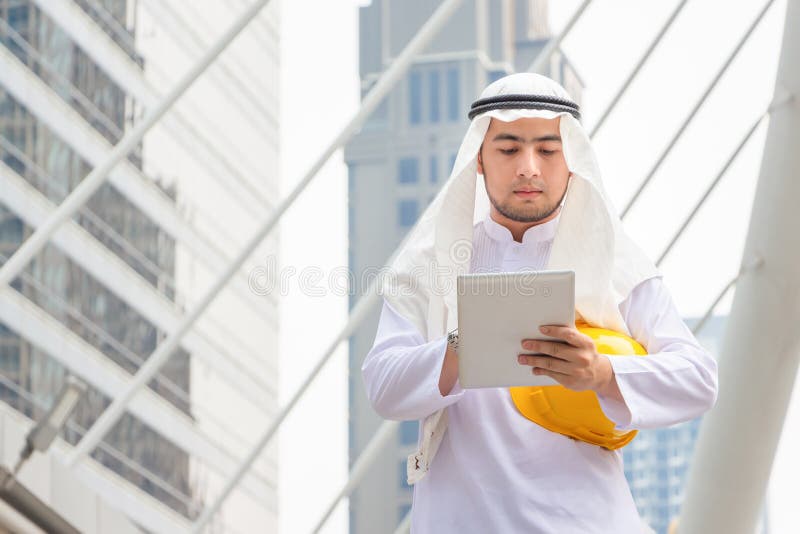 Young Saudi Skilled Professional Engineer Using Tablet Smartphone, Arab ...