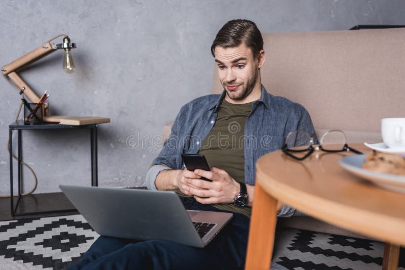 Young Sceptic Man Looking at Laptop while Sitting Stock Image - Image ...