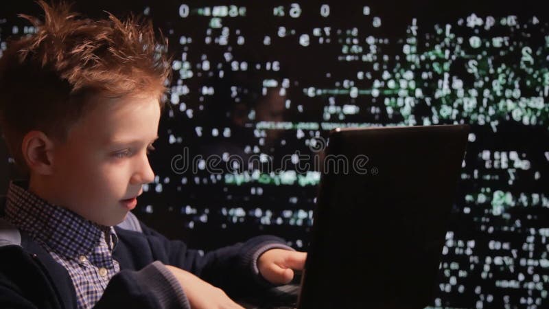 Young Schoolboy Prodigy - a Hacker. Hacker at Work. Lots of Digits on ...