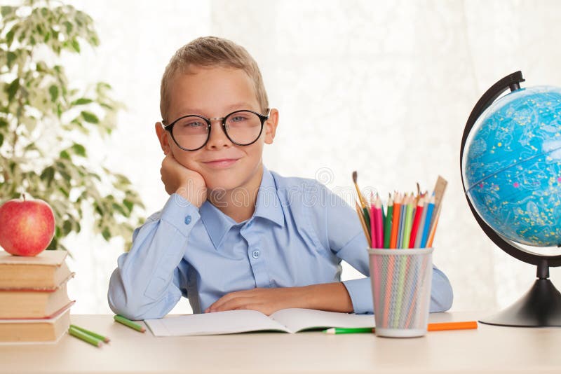Young Schoolboy Sitting at the Table and Doing Homework Stock Photo ... Young Schoolboy Sitting at the Table and Doing Homework Stock Photo ...