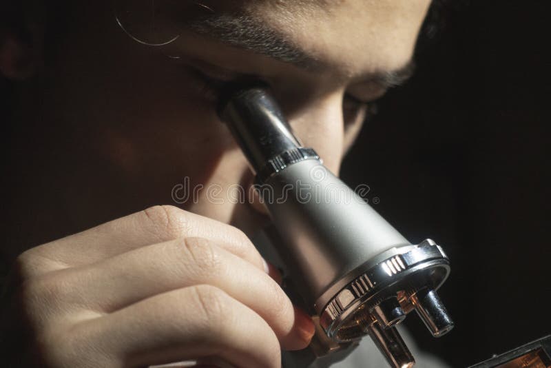 Young Science Student Doing Research Looking through His Microscope ...