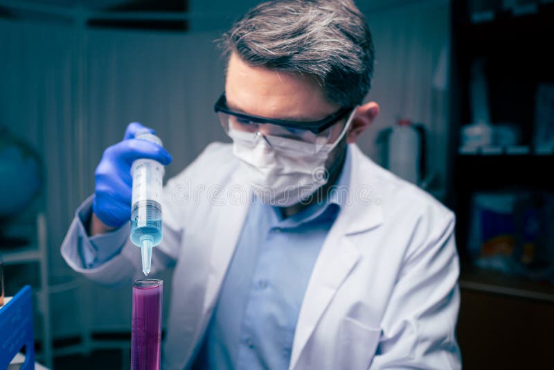 Young Scientist Checking Test Tubes in the Lab. Man Wears Protective ...