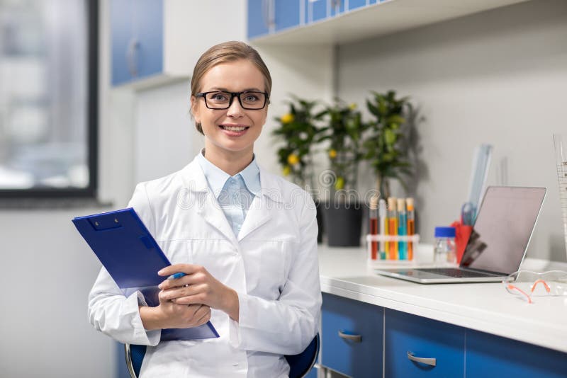 Young Scientist in Eyeglasses Holding Clipboard in Research Laboratory ...