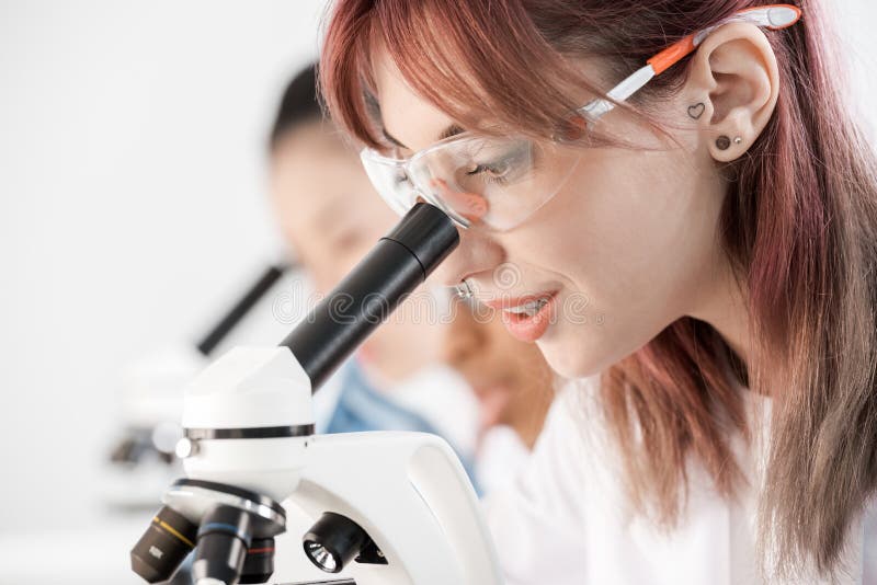 Young Scientist in Protective Goggles Working with Microscope in ...