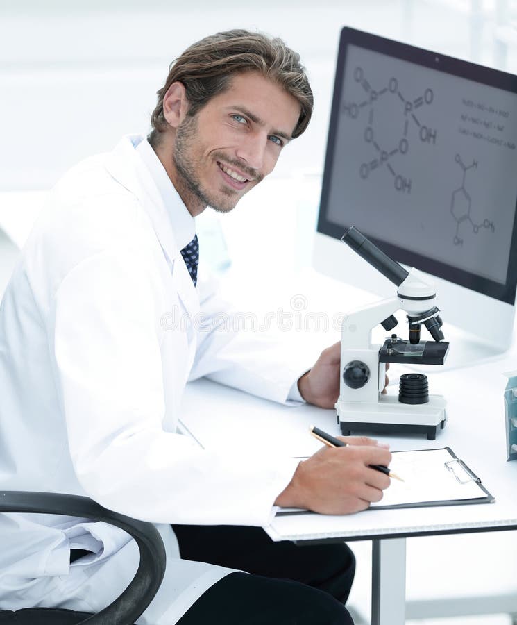 Laboratory Worker Sitting by Table with Microscope Stock Photo - Image ...