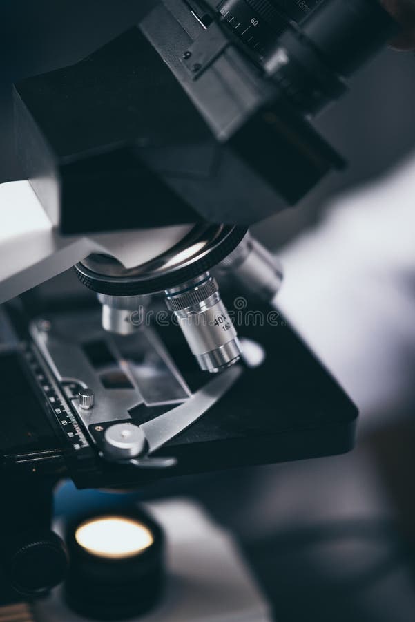 Young Scientist Working with a Microscope in a Laboratory. Young ...
