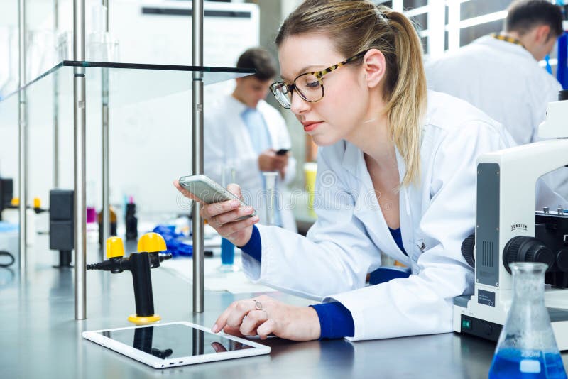 Young Scientists Carrying Out an Experiment in a Laboratory. Stock ...