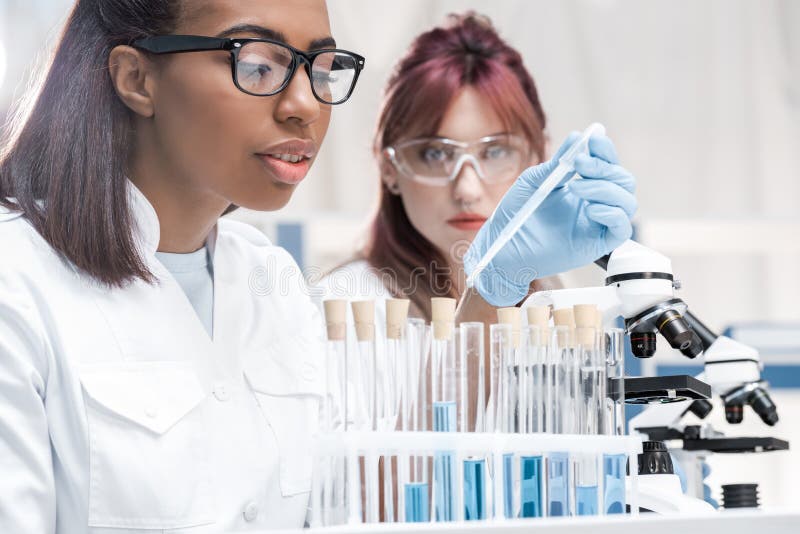 Young Scientists Working with Microscope and Test Tubes in Chemical ...