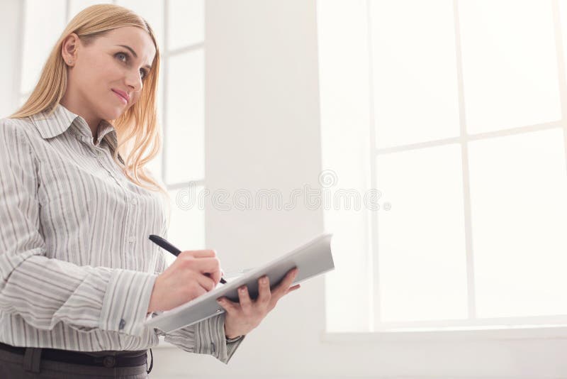 Young Secretary Standing in Office and Writing Notes Stock Image ...