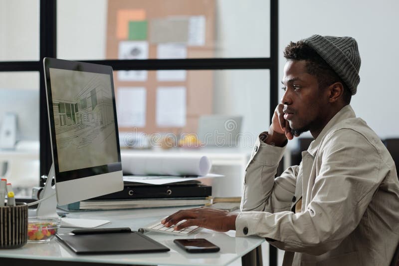 Young Serious Male Architect or Designer Looking at Computer Screen ... Young Serious Male Architect or Designer Looking at Computer Screen ...