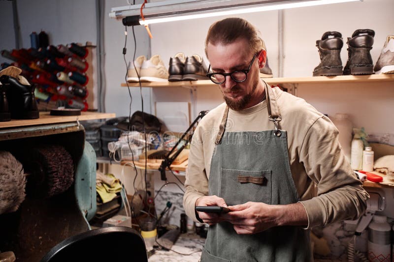 Man on phone in workshop stock image. Image of anonymous - 315449639