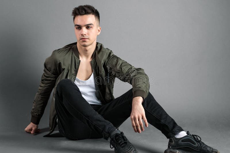 Young Serious Man Posing in Studio. Gray Background Stock Image - Image ...