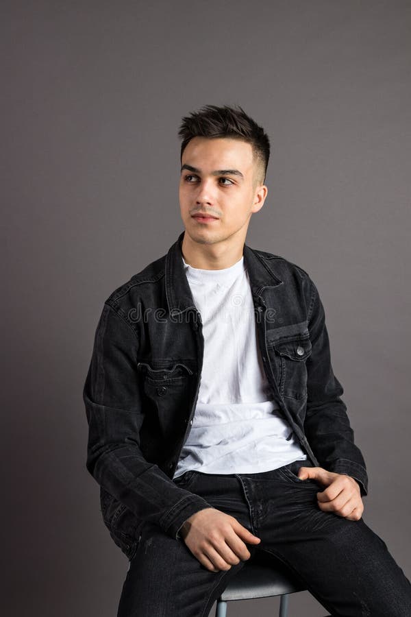 Young Serious Man Posing in Studio. Gray Background Stock Photo - Image ...