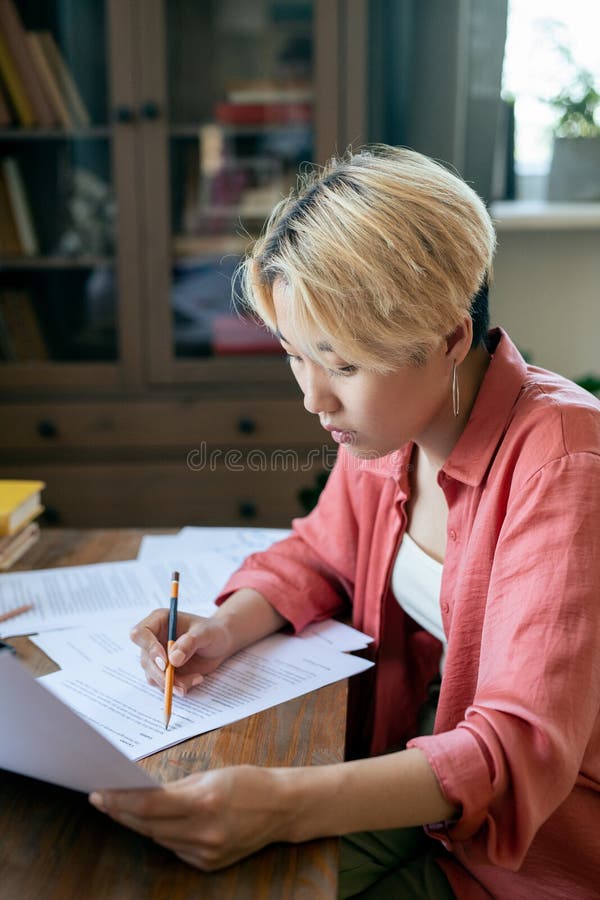 Young Serious Student or Freelancer Looking through Papers Stock Image ...