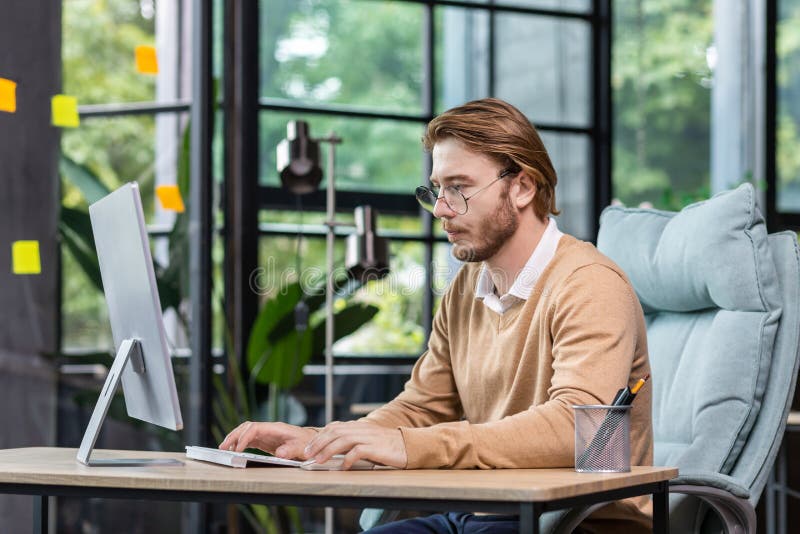 Young Serious Thinking Businessman at Work Inside Office with Computer ...