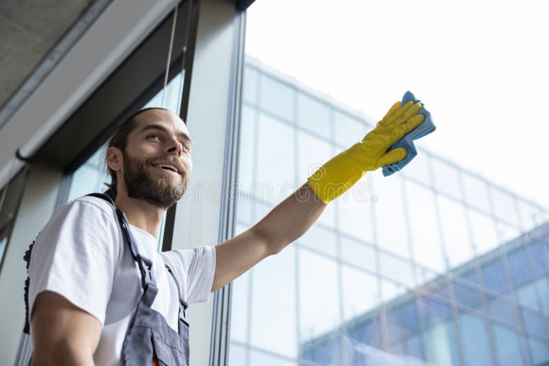 Young Service Man Cleaning Windows Office Looking Busy Stock Photos ...