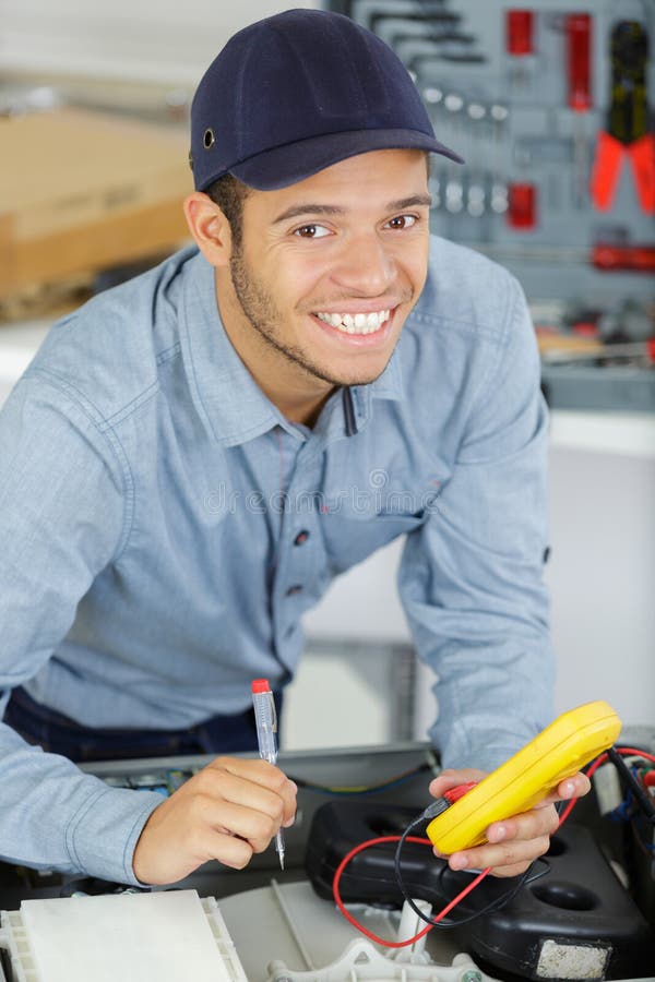 Young Serviceman Installing Oven in Kitchen Stock Image - Image of ...