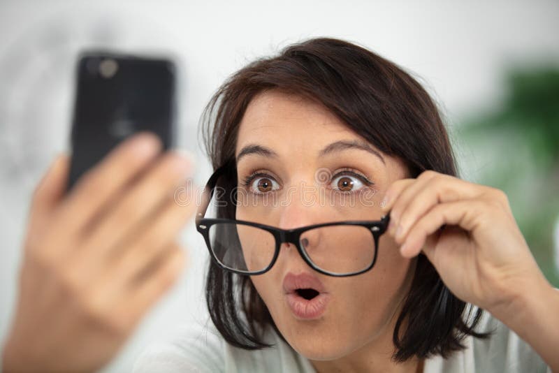 Young Shocked Woman Looking at Mobile Phone Screen Stock Image - Image ...